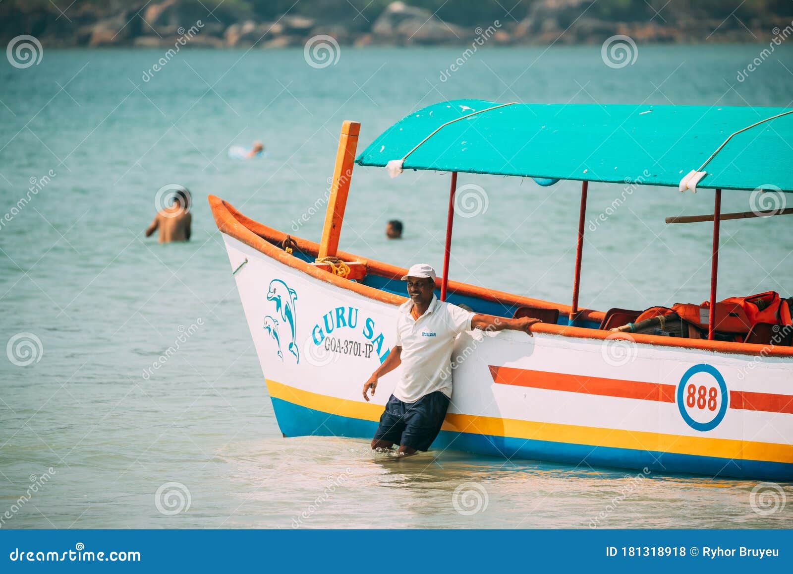 Canacona, Goa, India. Man Pushing Sightseeing Boat from Sea To Shore ... Canacona, Goa, India. Man Pushing Sightseeing Boat from Sea To Shore ...