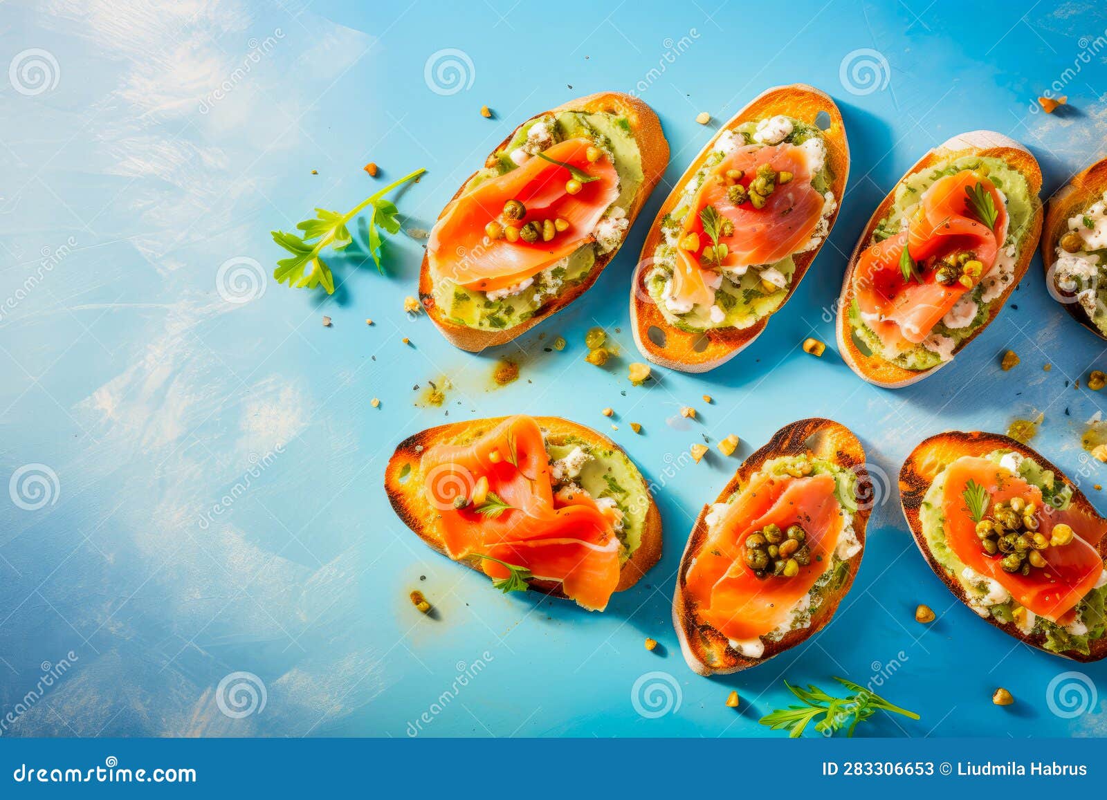 Canapes with Salmon, Cream Cheese and Microgreens on Blue Background ...