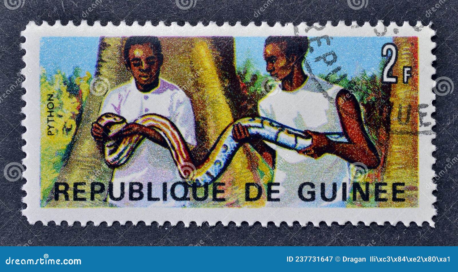 Cancelled Postage Stamp Printed by Guinea, that Shows Men Holding Rock ...