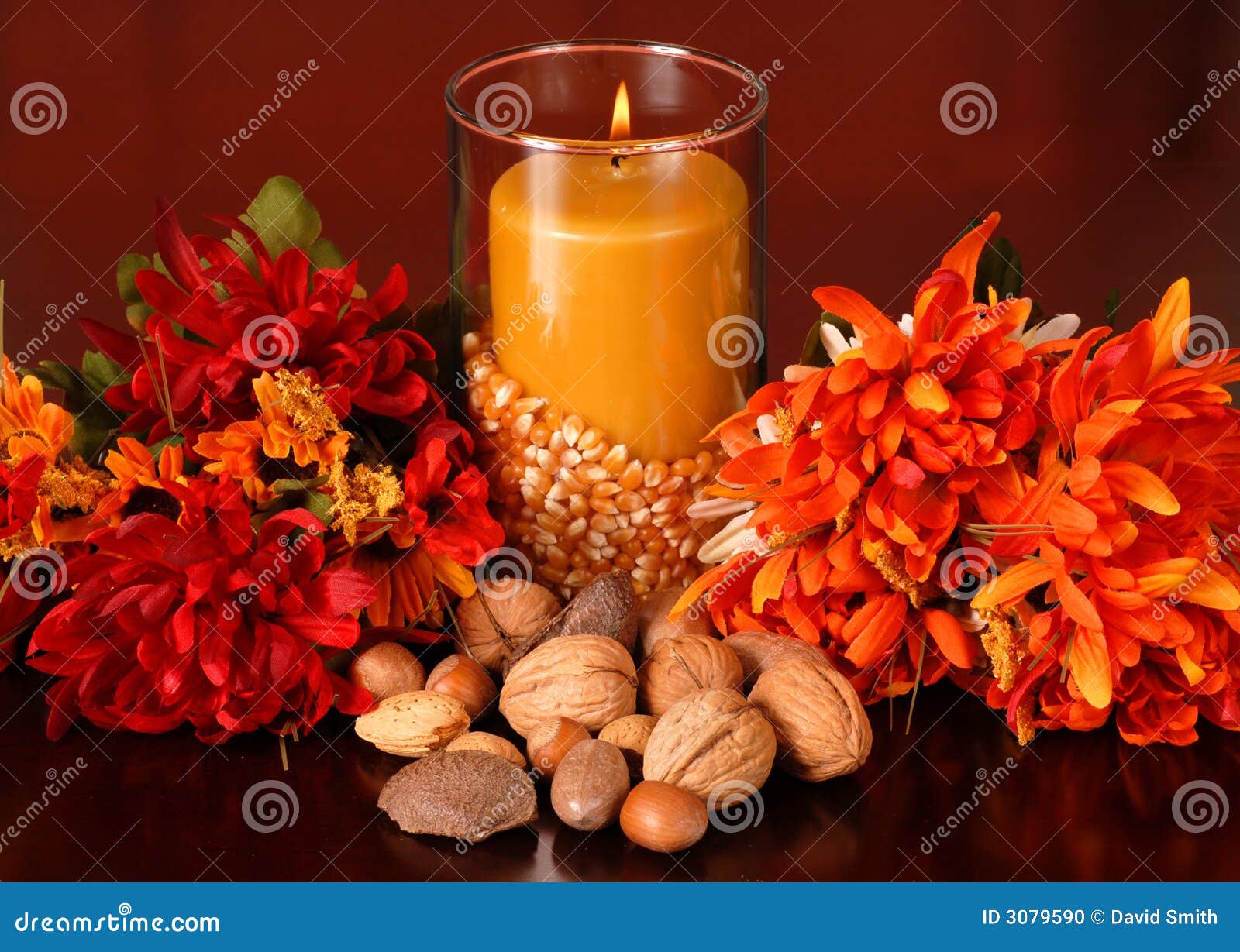A Candle in an Autumn Setting Stock Photo - Image of flowers, kernels ...