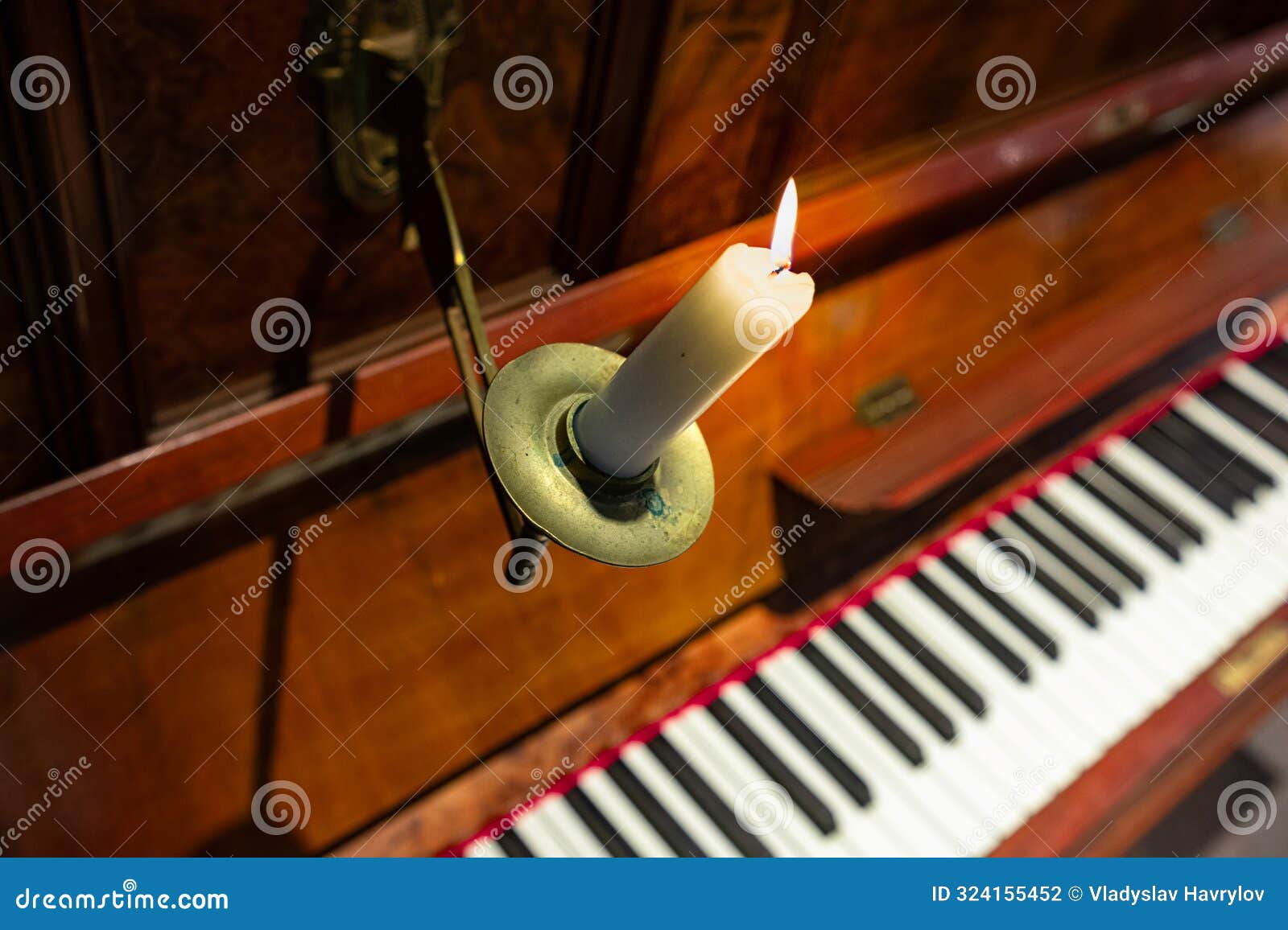 A Candle Burns on a Candlestick Mounted on a Piano. a Candle Burns Over ...