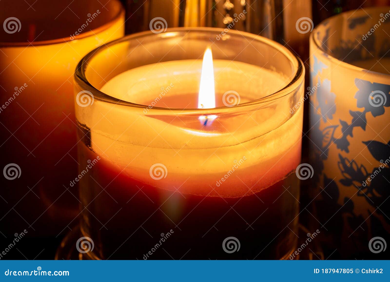 Candle in Glass Texture Illuminating Nearby Objects in Low Light Stock ...