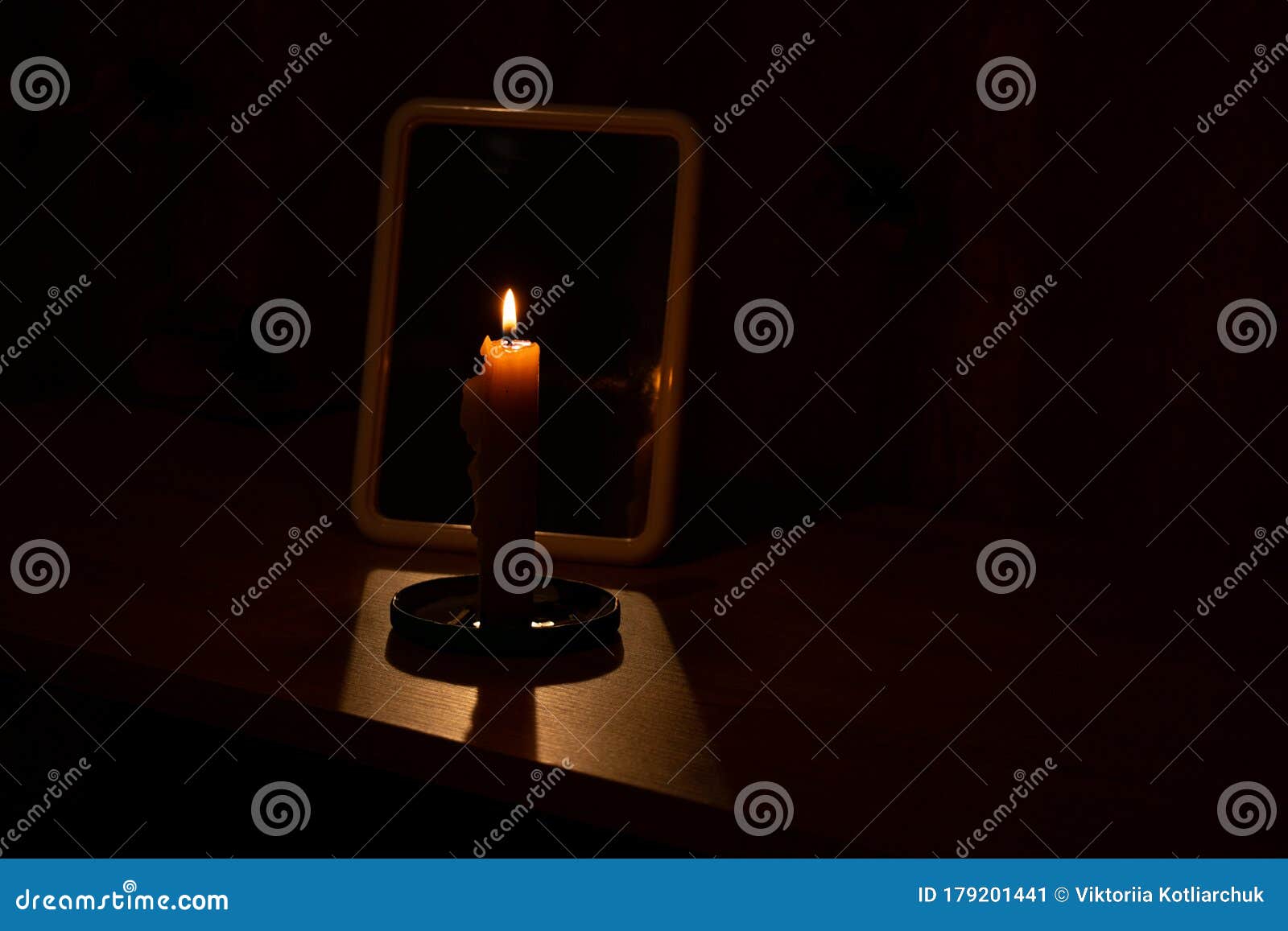 Candle Light in the Reflection of a Mirror Standing on a Table in a ...