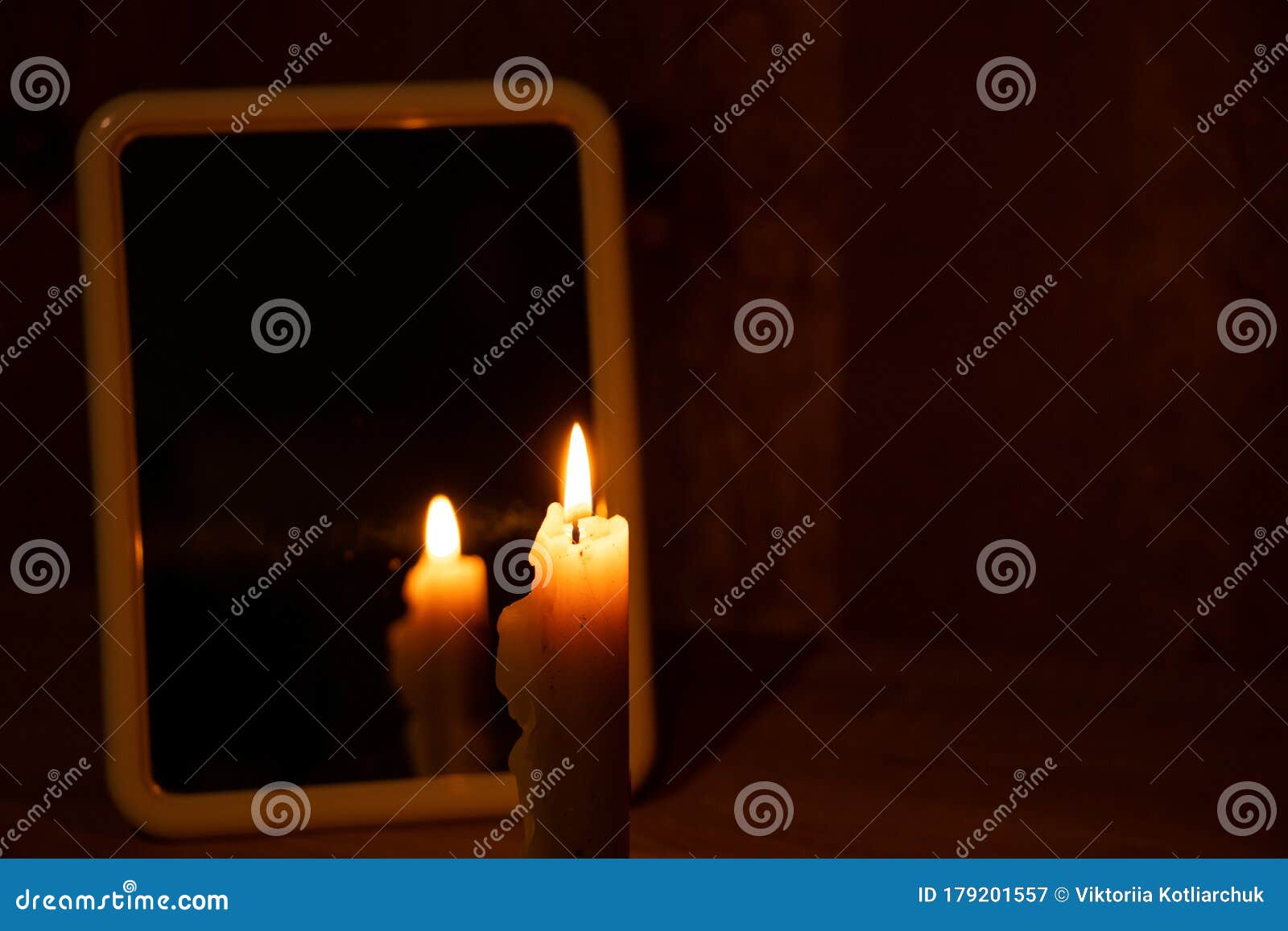 Candle Light in the Reflection of a Mirror Standing on a Table in a ...
