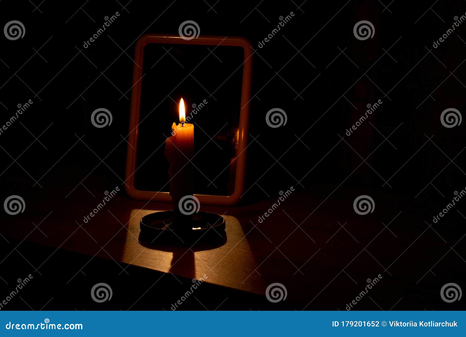 Candle Light in the Reflection of a Mirror Standing on a Table in a ...