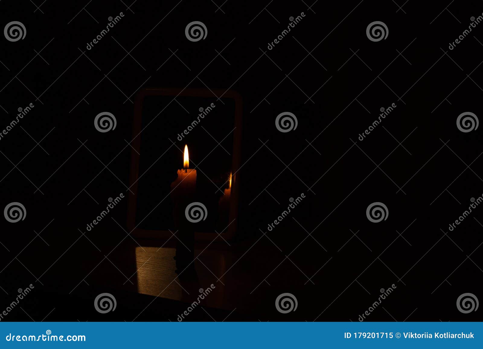 Candle Light in the Reflection of a Mirror Standing on a Table in a ...