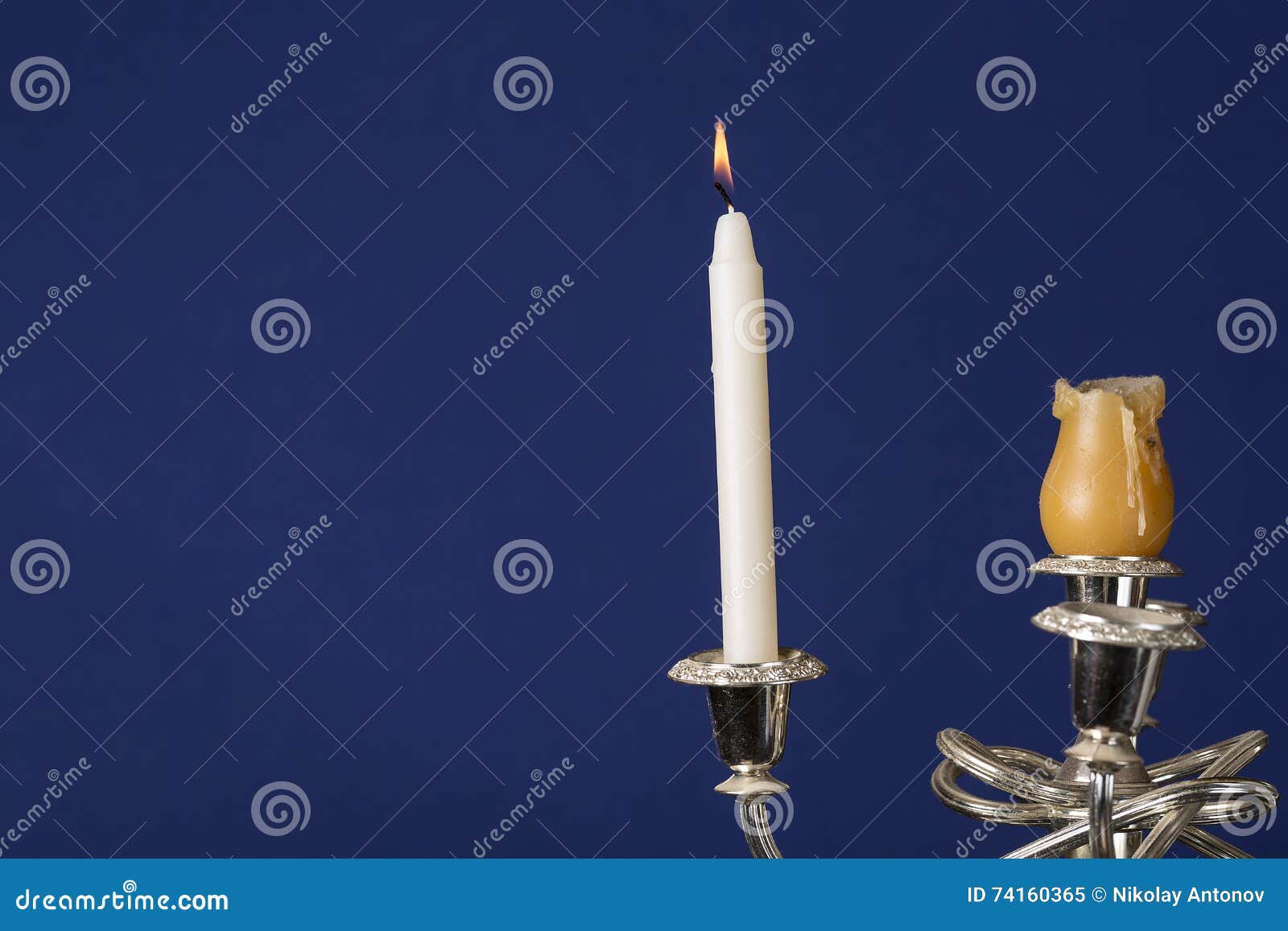Candlestick with Burning Candle on Blue Background Stock Image - Image ...