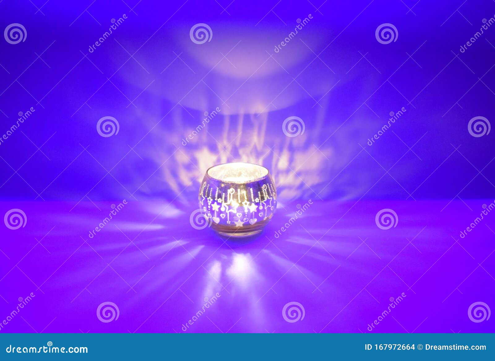 Candlestick and a Magic Glow from it on a Blue Background Stock Photo ...