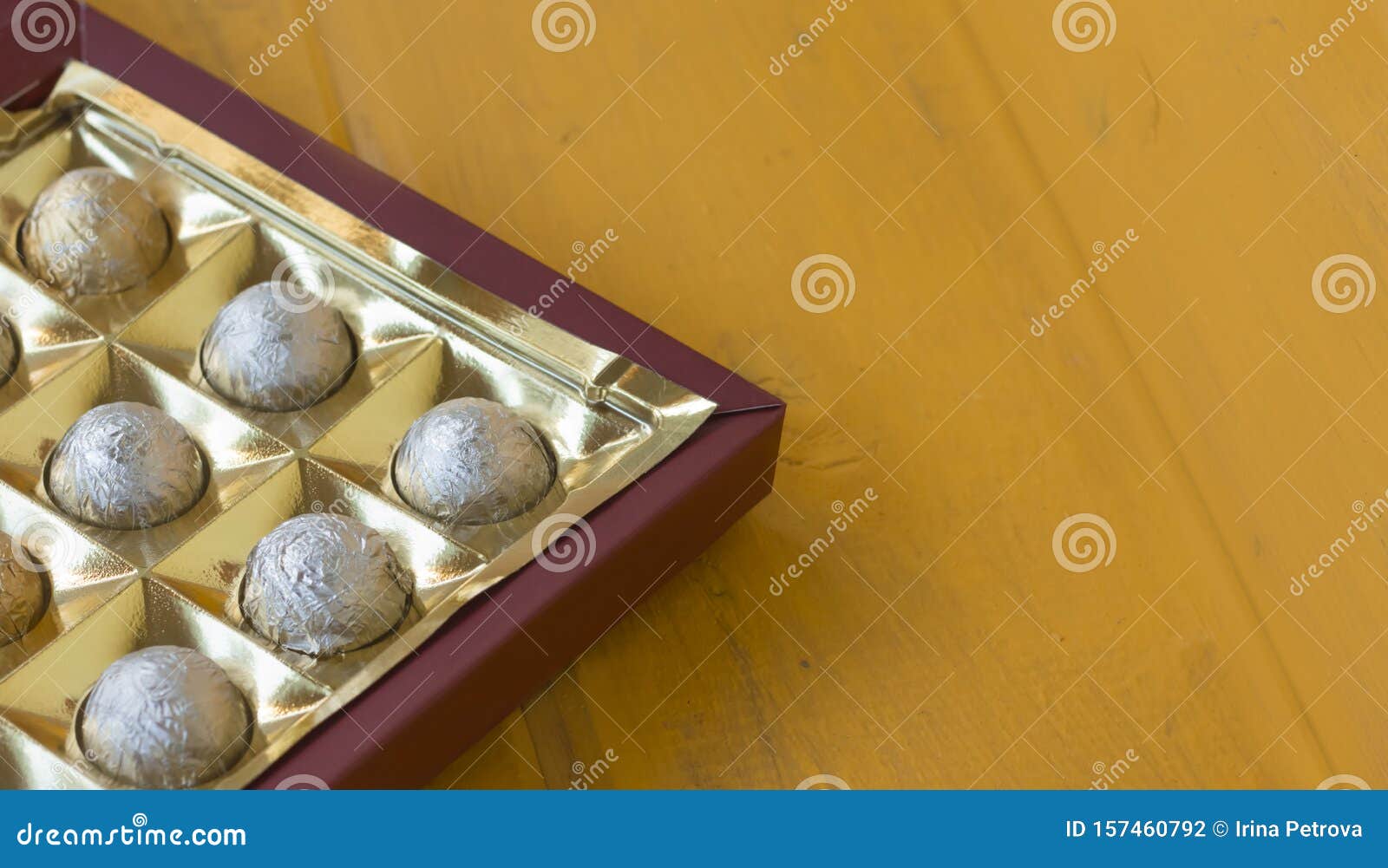 Candy in Silver Wrapper in Box on Yellow Background with Copy Space ...