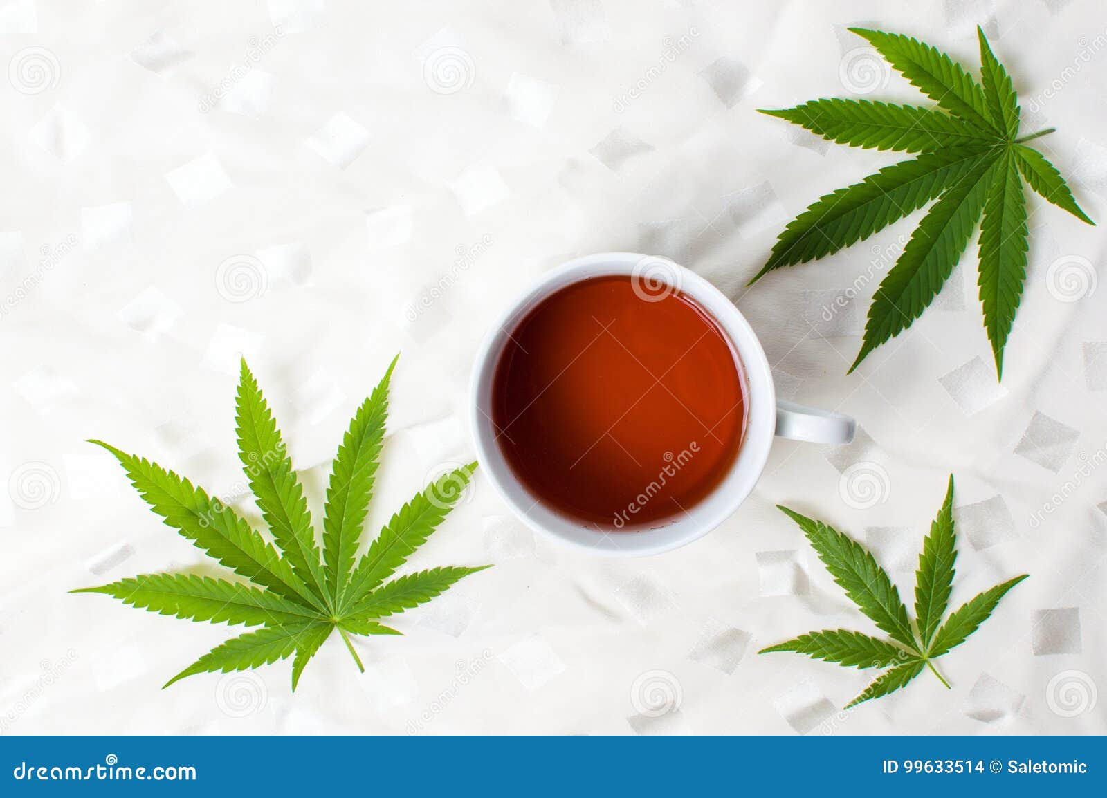 Cannabis Tea and Marijuana Leaves on White Fabric Stock Photo - Image ...