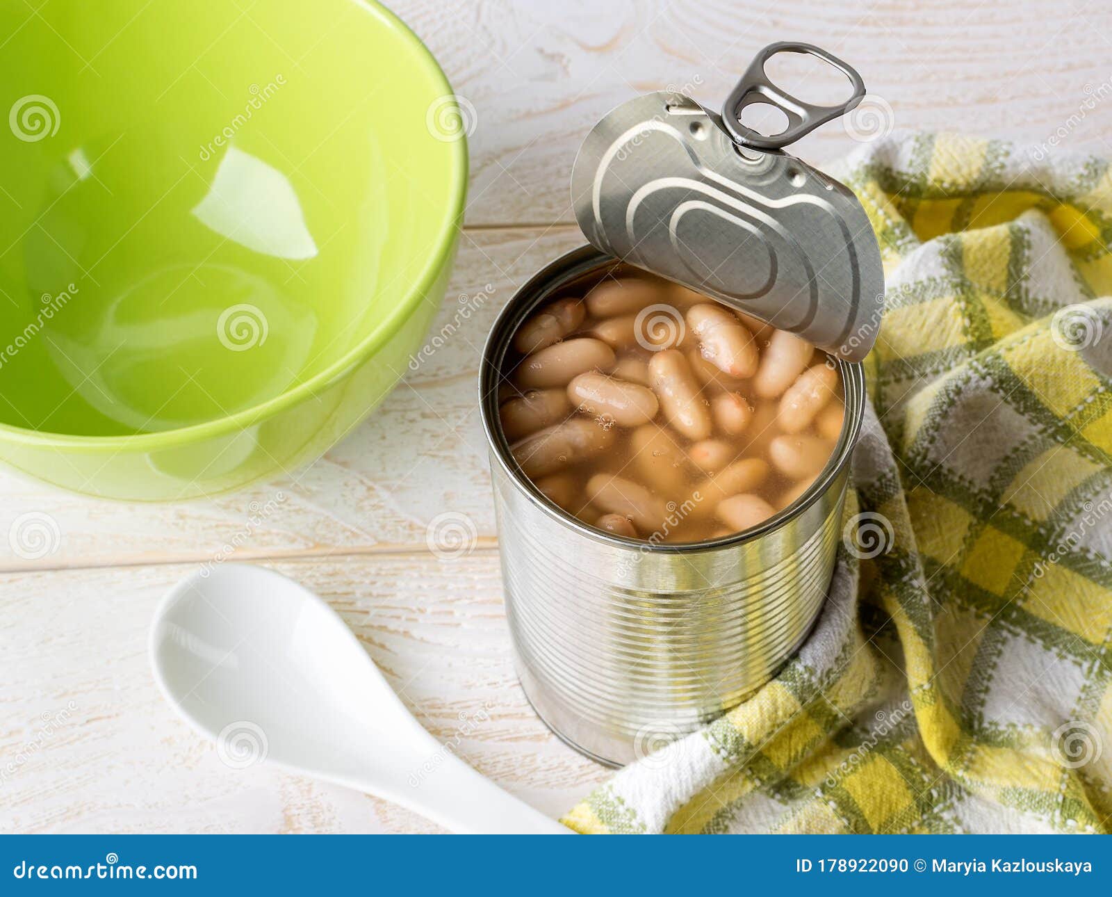 Canned Backed Beans in an Open Tin Can with Pull Tab Near Ceramic Bowl ...