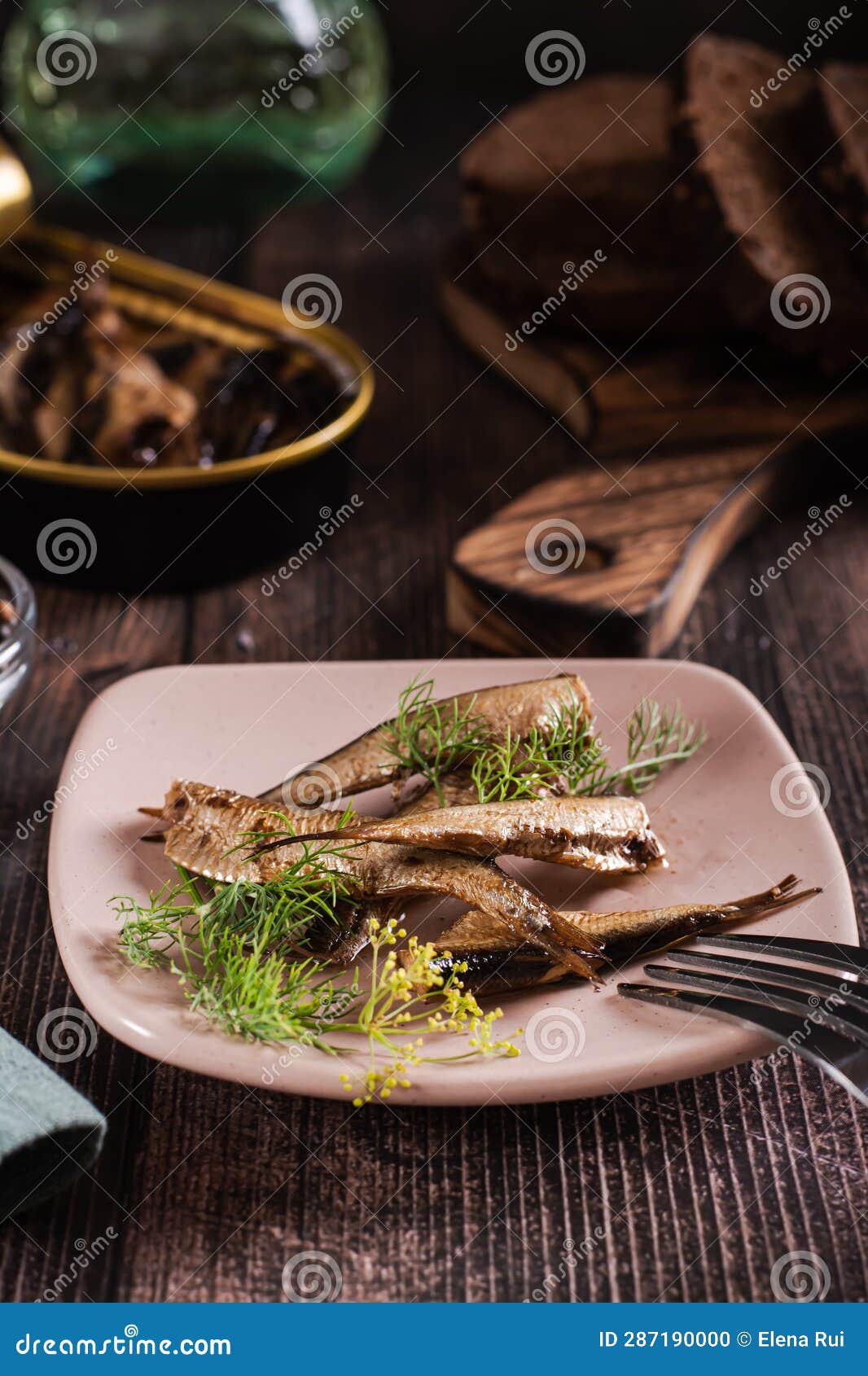 Canned Sprats Fish in Oil and Dill on a Plate on the Table Vertical ...