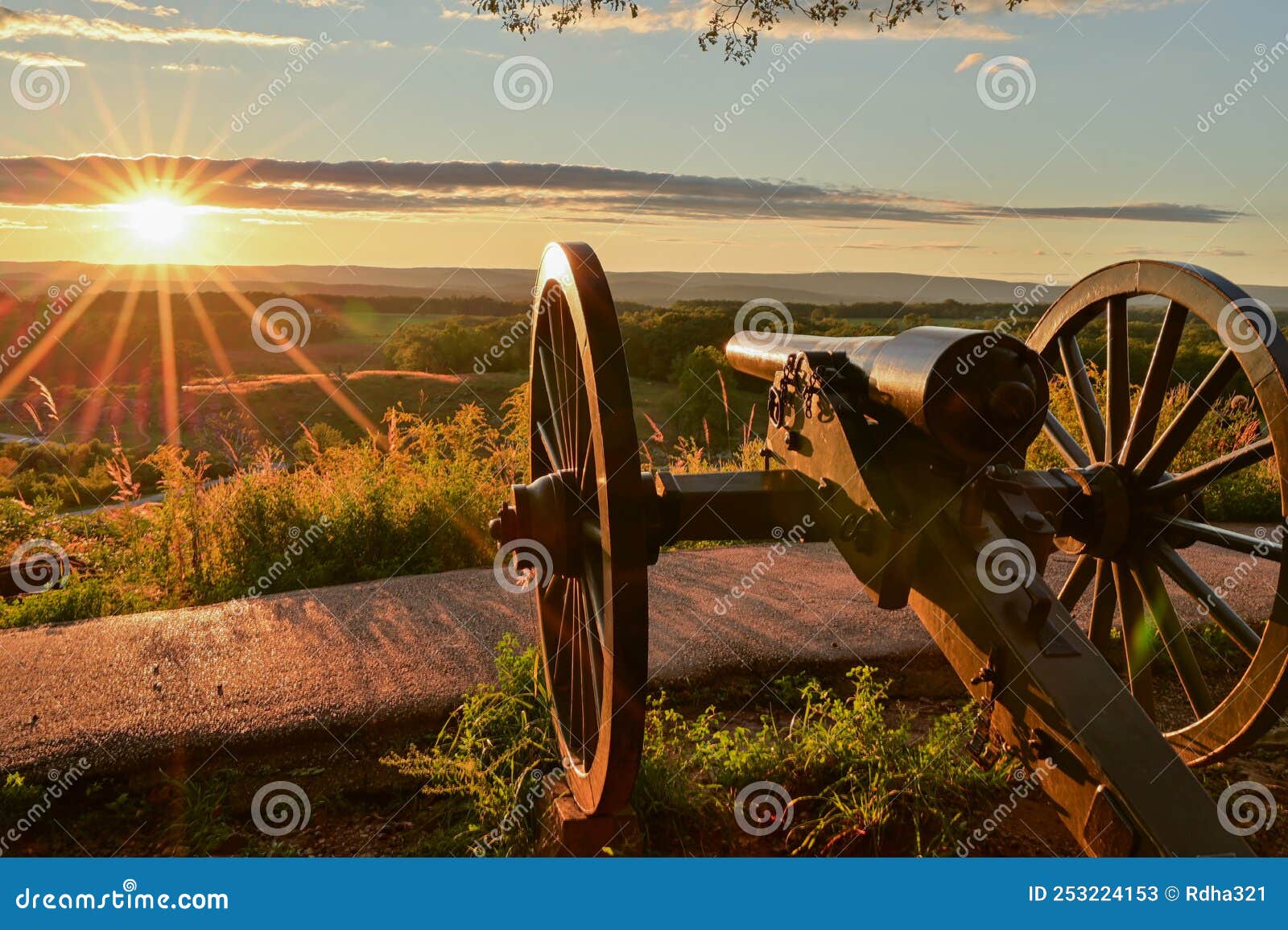 A Cannon Overlooking Field with Shadows at Golden Hour Stock Image ...