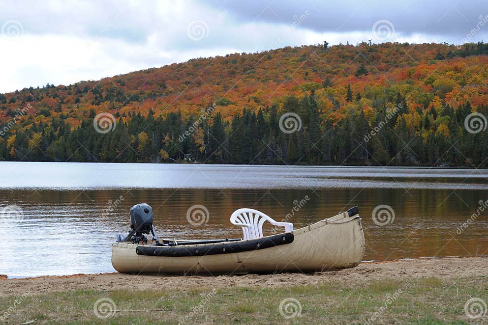 Canoe with chair and motor stock photo. Image of shoreline - 11473744