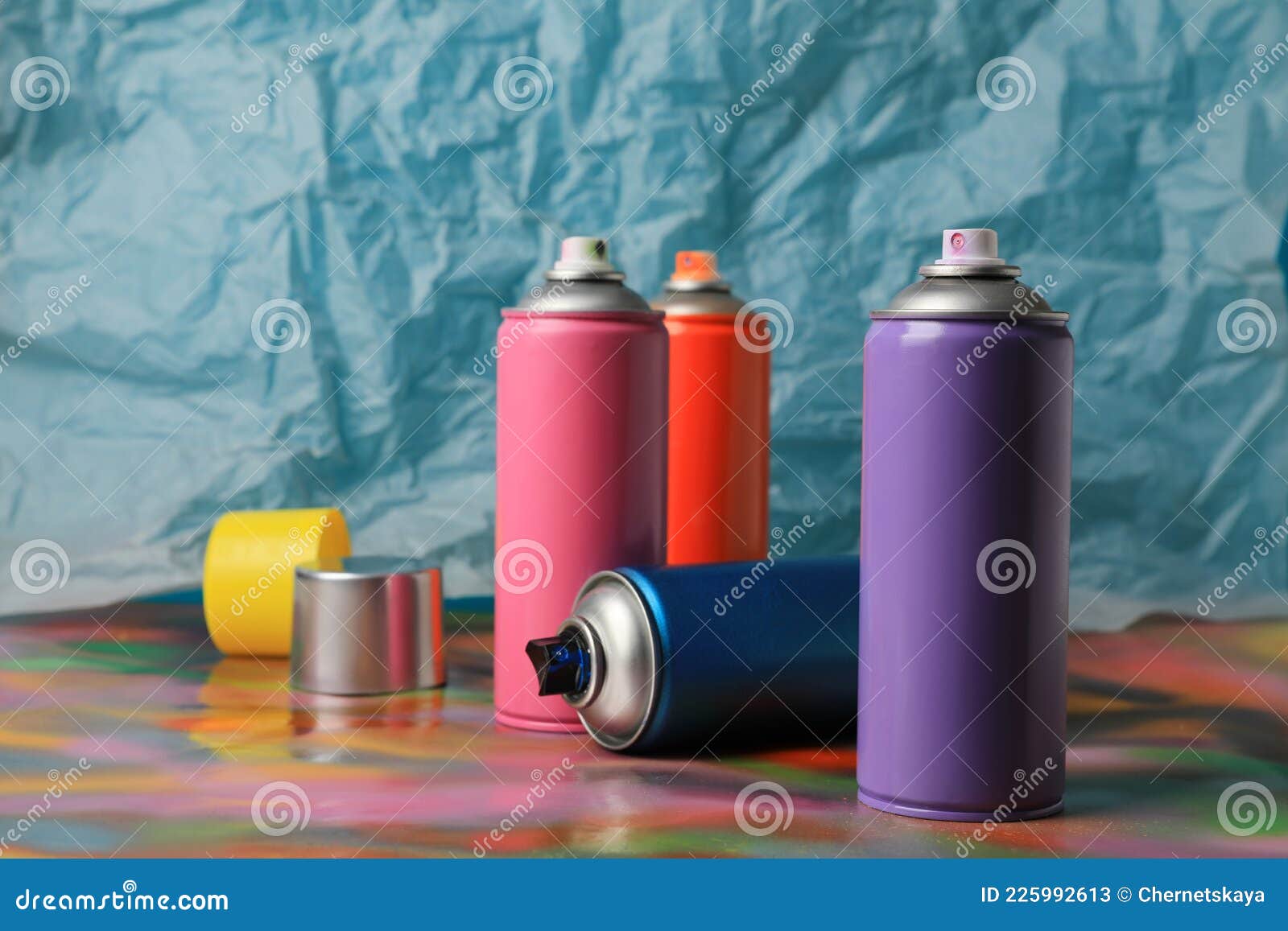 Cans of Different Graffiti Spray Paints on Color Background Stock Image ...