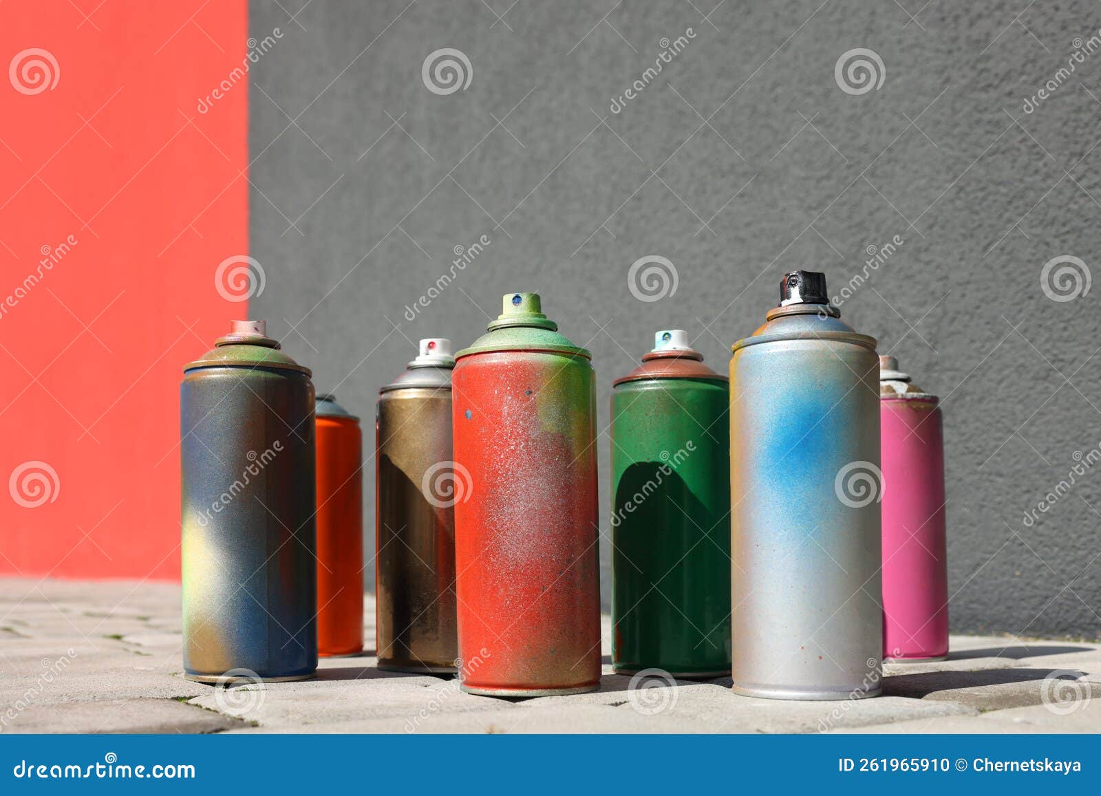 Cans of Different Spray Paints on Pavement Near Wall Stock Photo ...