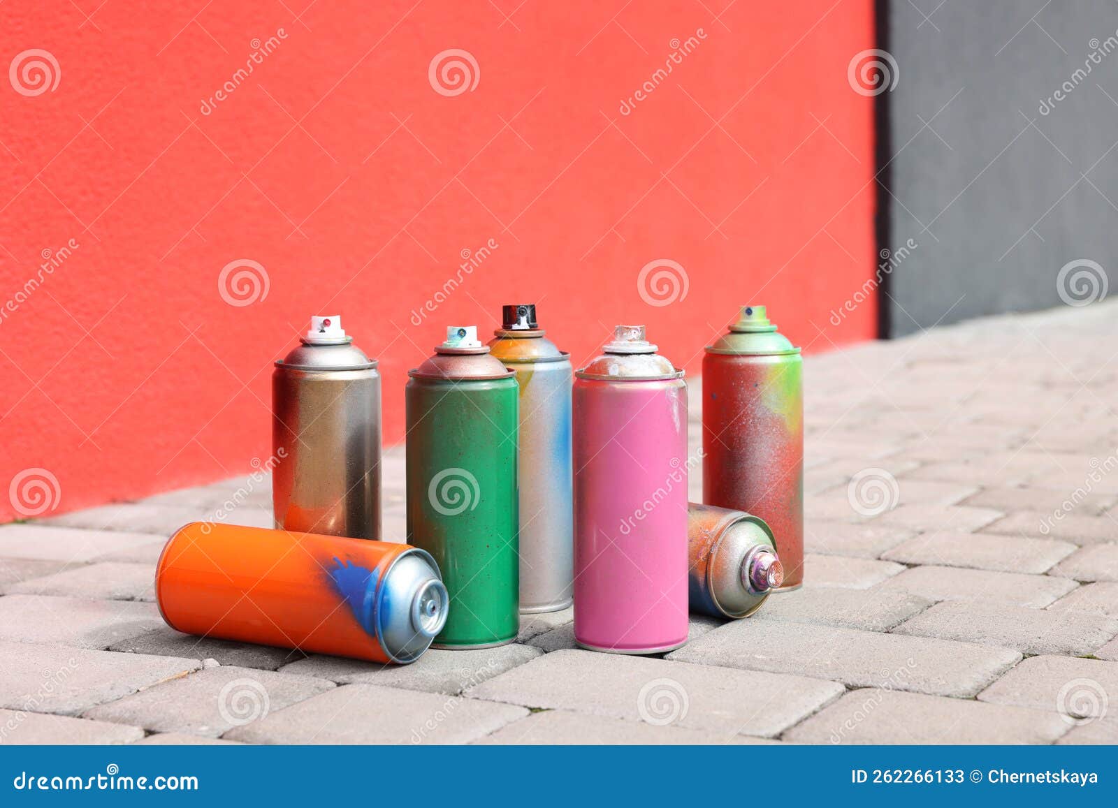 Cans of Different Spray Paints on Pavement Near Wall Stock Image ...