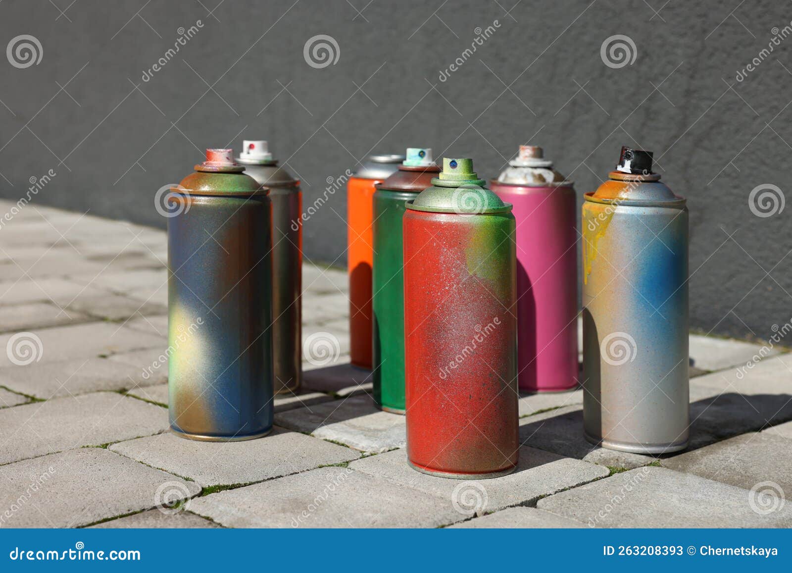 Cans of Different Spray Paints on Pavement Near Wall Stock Image ...