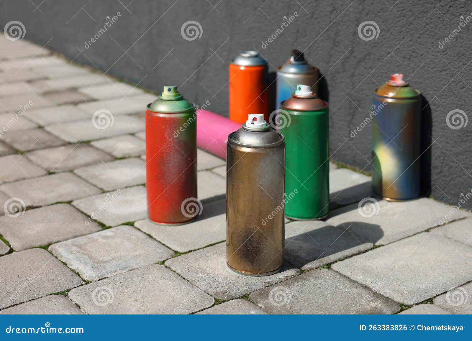Cans of Different Spray Paints on Pavement Near Wall Stock Photo ...