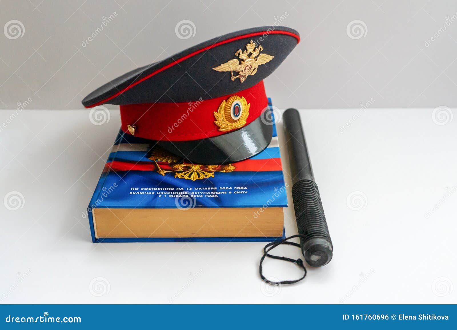 The Cap of a Russian Police Officer and a Rubber Baton is on the Code ...