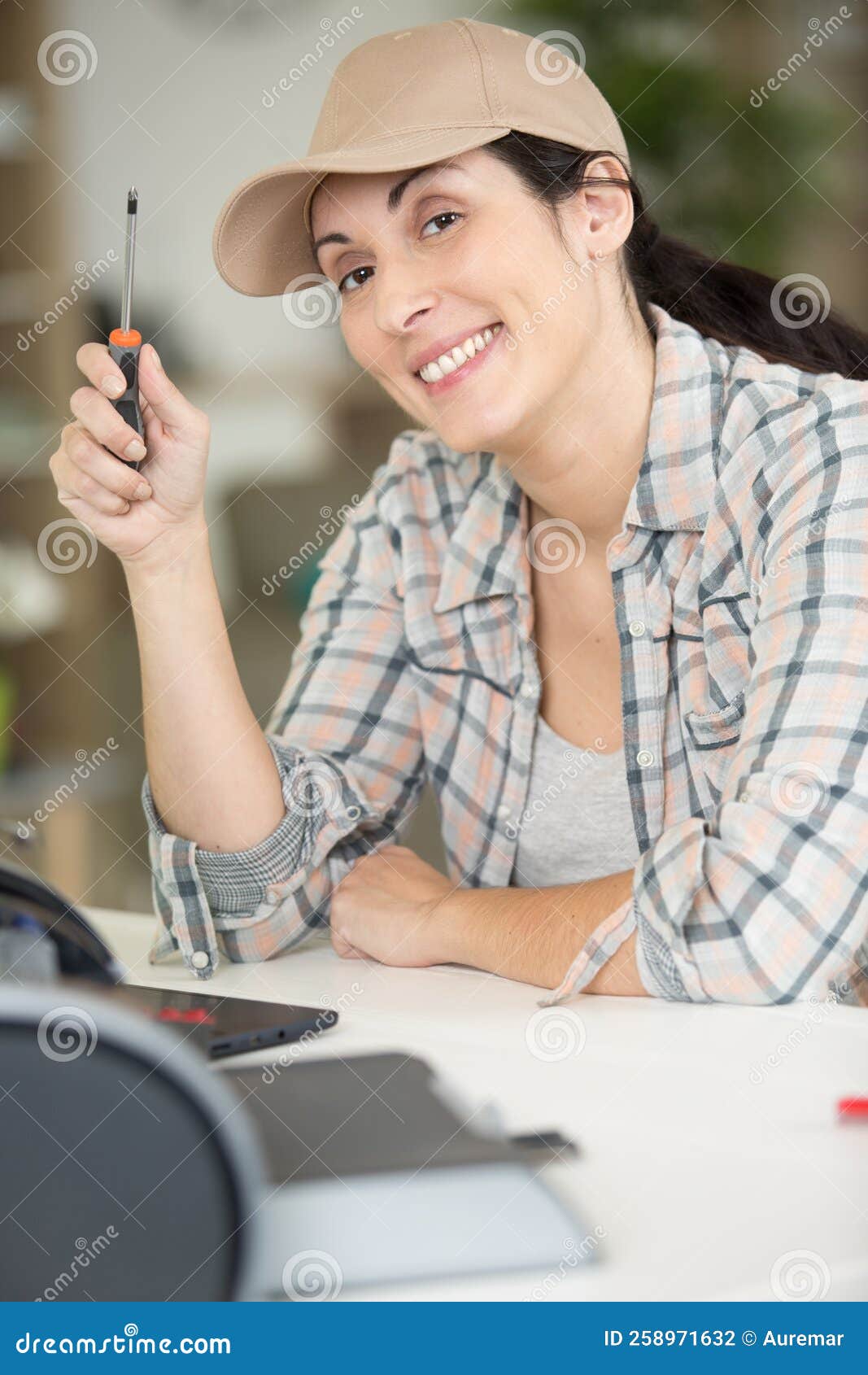 Capable Woman Sat at Desk Holding Screwdriver Stock Photo - Image of ...