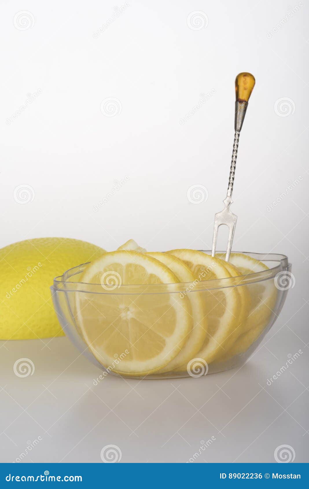 Capacity for Lemon, Fork for Lemon and Sliced Lemon Stock Photo - Image ...