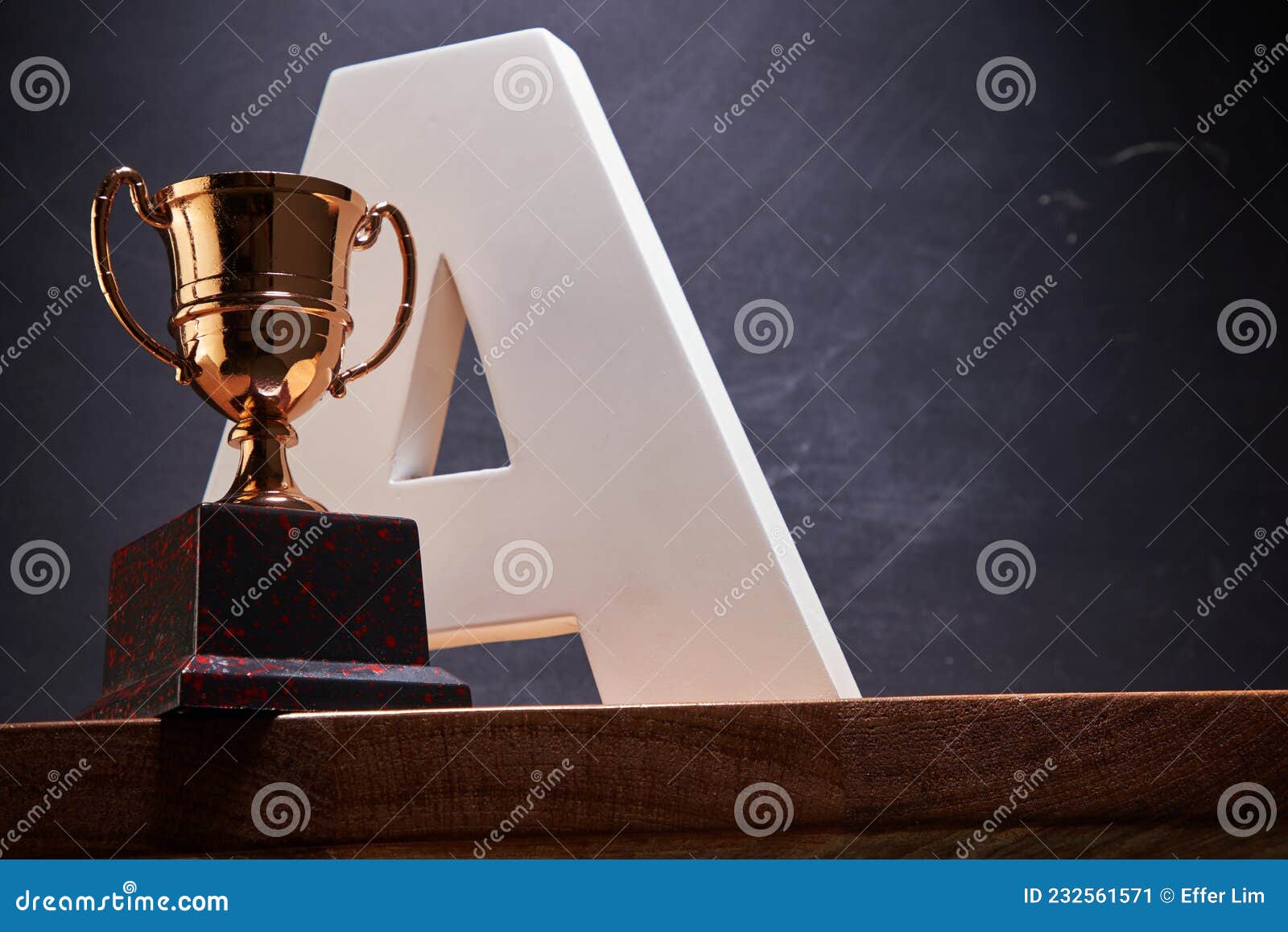 Capital Letter a and Wining Trophy Against Blackboard Stock Image ...