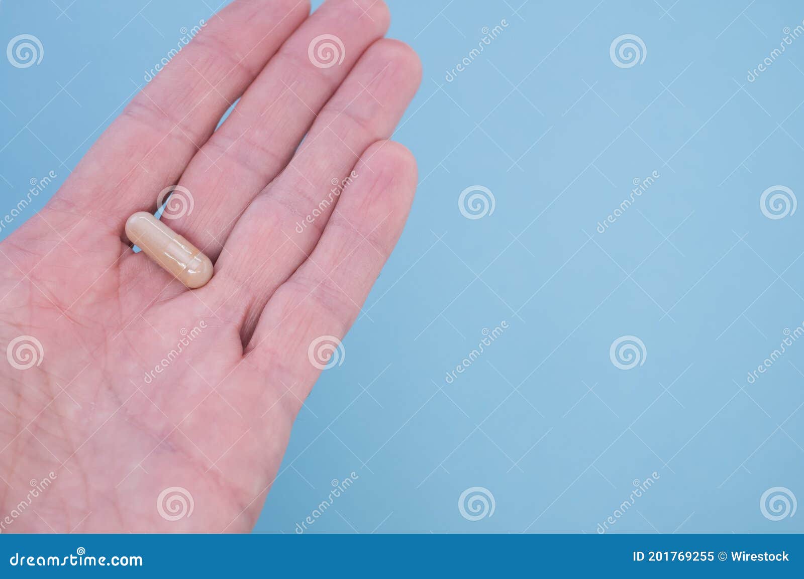 Capsule on a Hand Palm on Blue Background with a Copy Space Stock Image ...