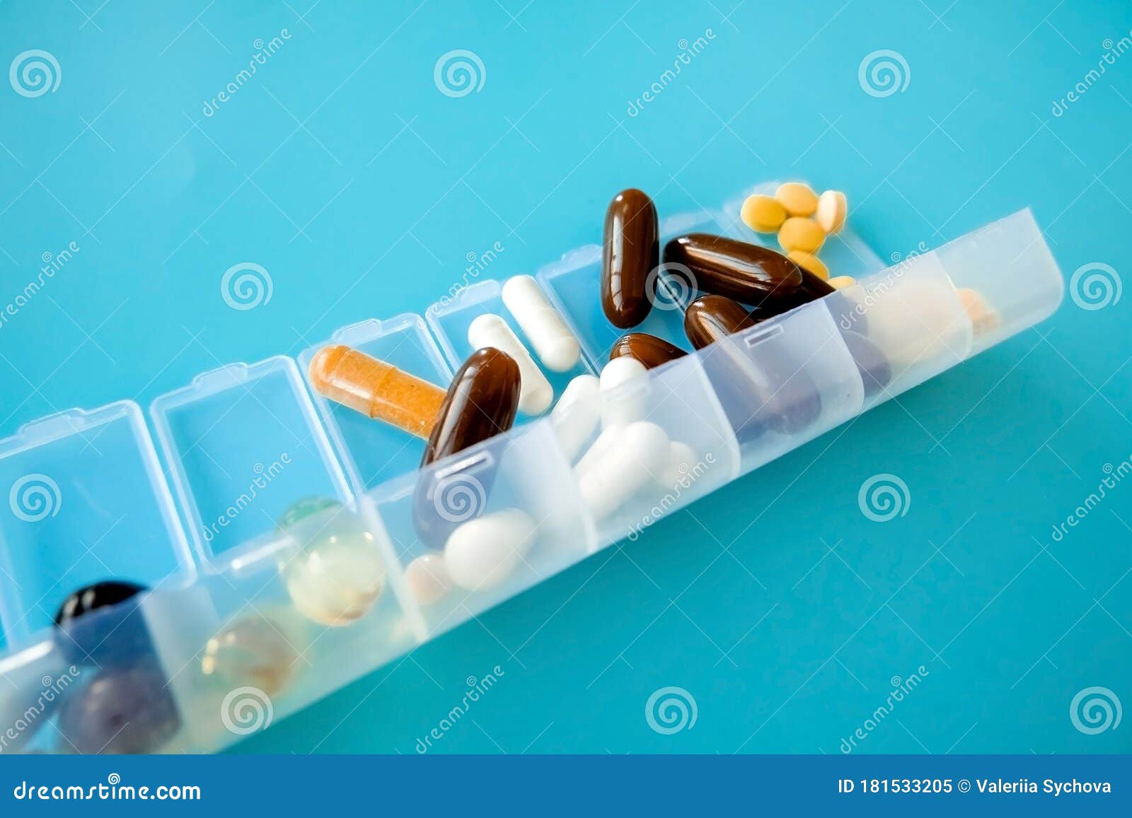 Capsules Lie in a Pill Box on a Blue Background. Box for Packing ...