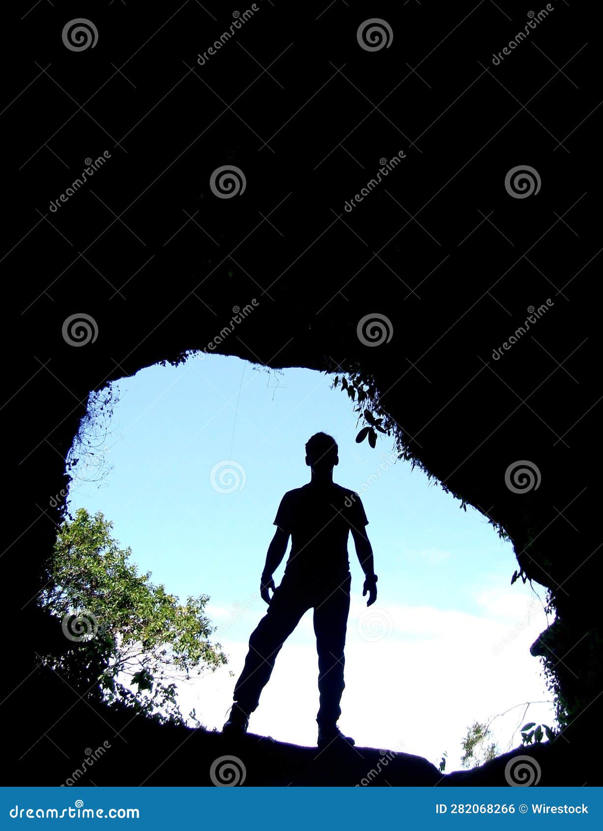 Silhouette of a Man in Backlit Entrance, Inside View of a Cave Stock ...