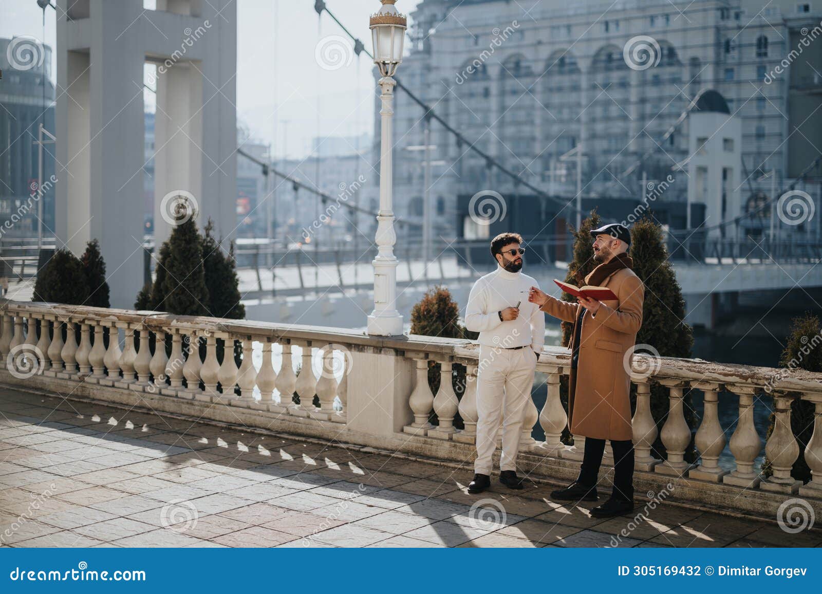 Two Stylish Men Engaging in a Lively Conversation Outdoors in the City ...