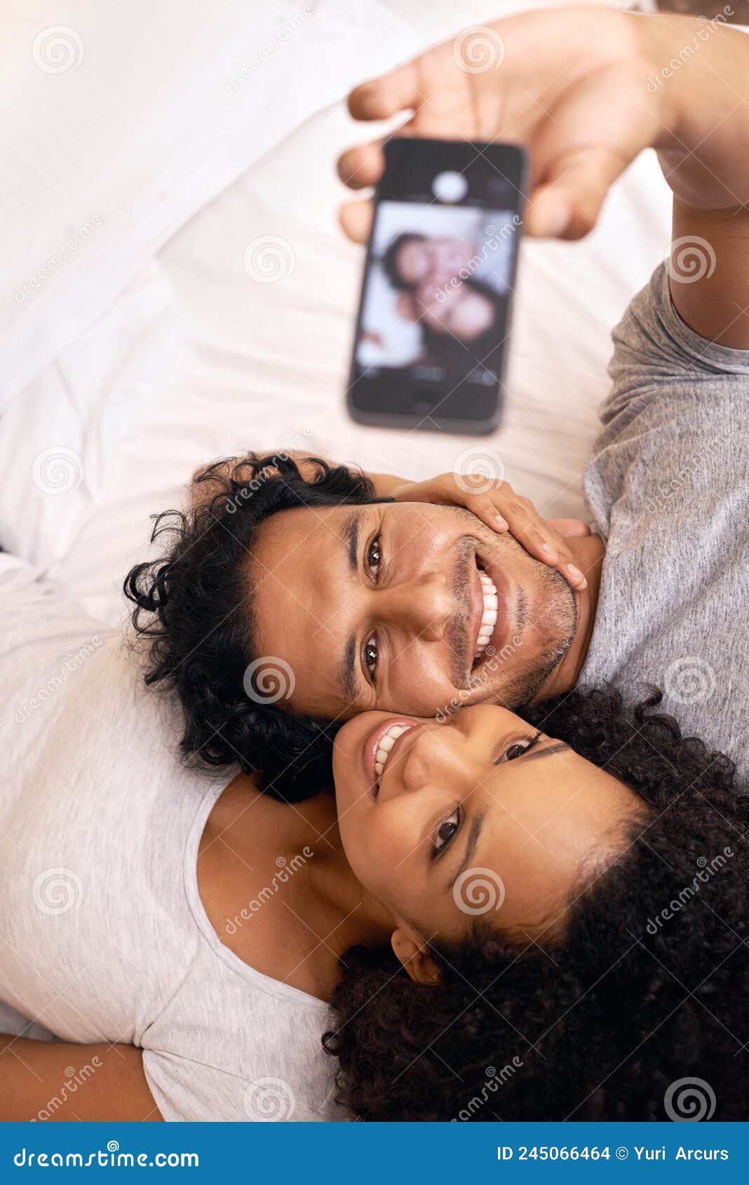 Capturing A Memory A Cute Couple Taking A Selfie On The Bed Stock