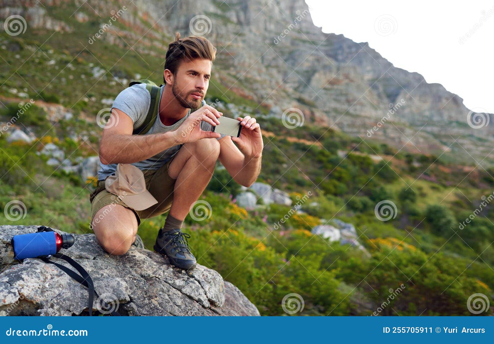 Capturing the Moment. a Handsome Young Man Snapping Pics while Hiking ...