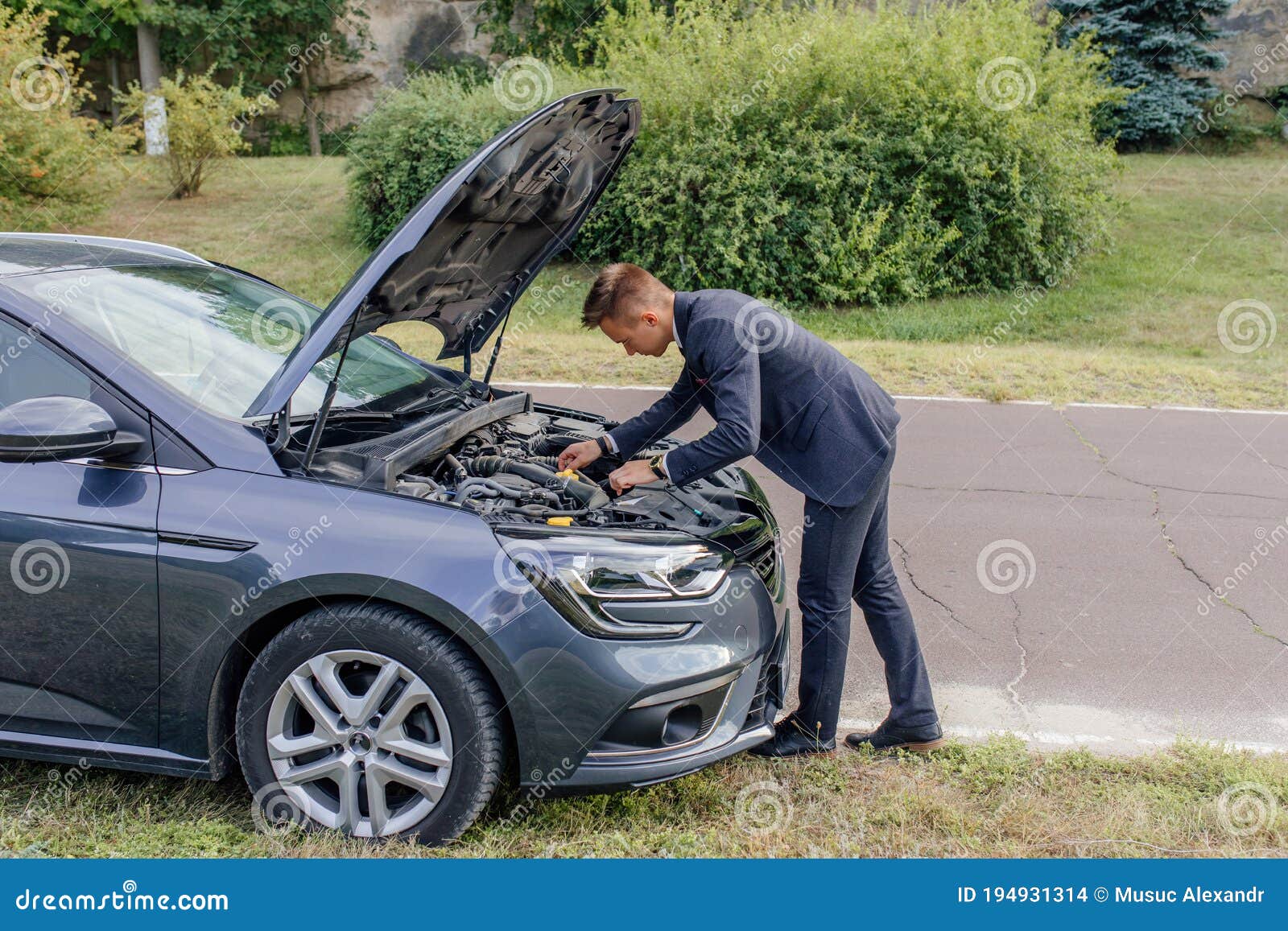 Car Breakdown. Side View of Concentrated Young Man Examine the Engine ...