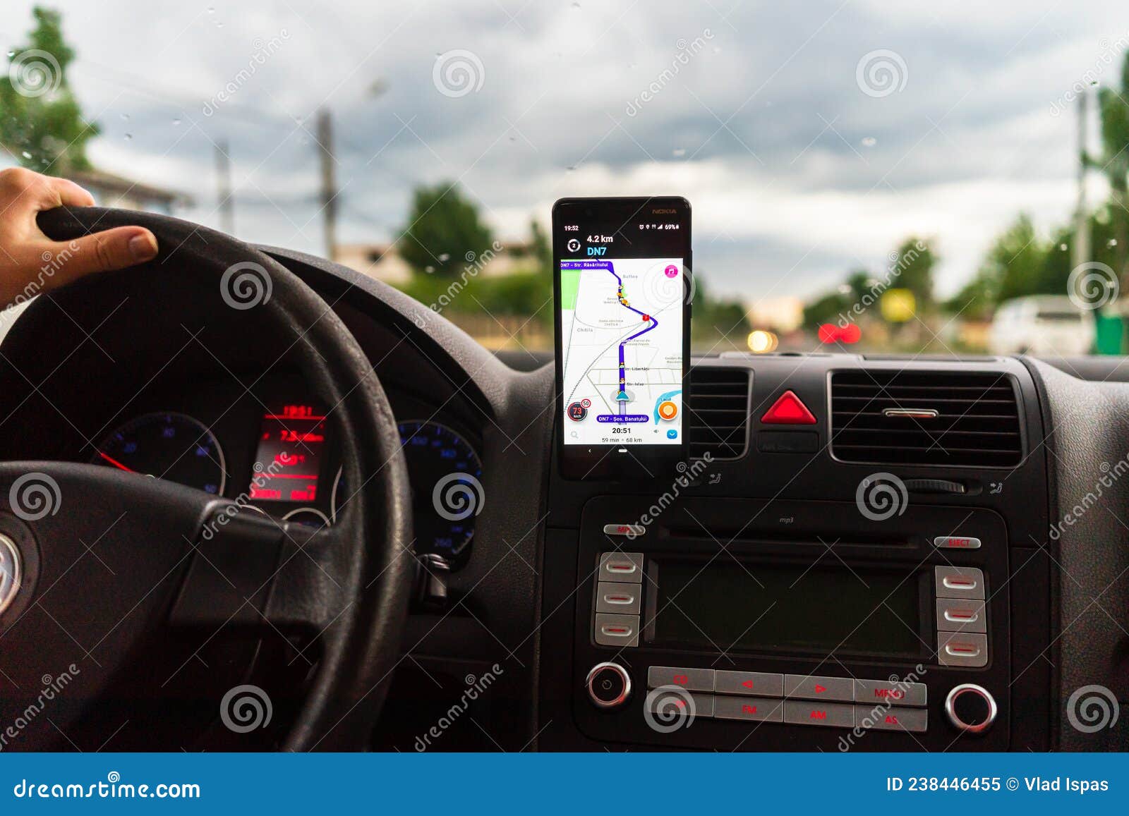 In Car Dashboard View with Smartphone on Waze Maps. Driver Using Waze ...