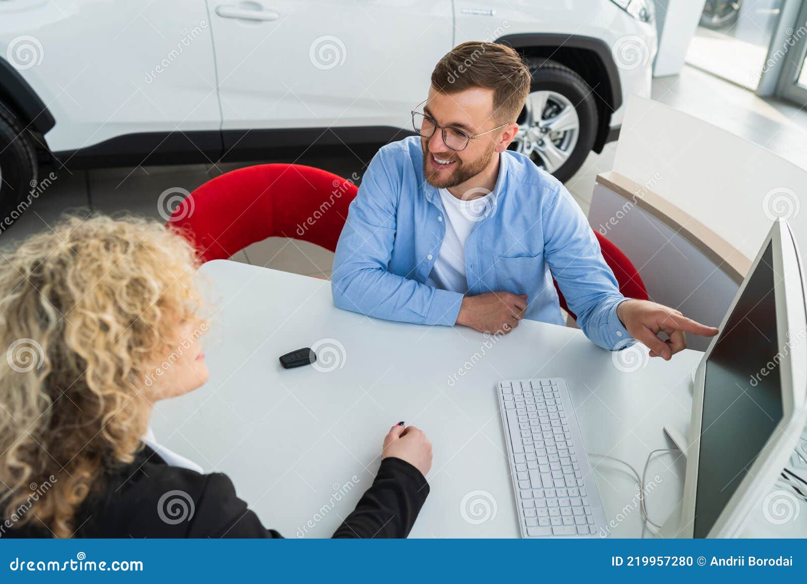 Car Dealership Manager with Client at Computer in Showroom. Stock Photo ...