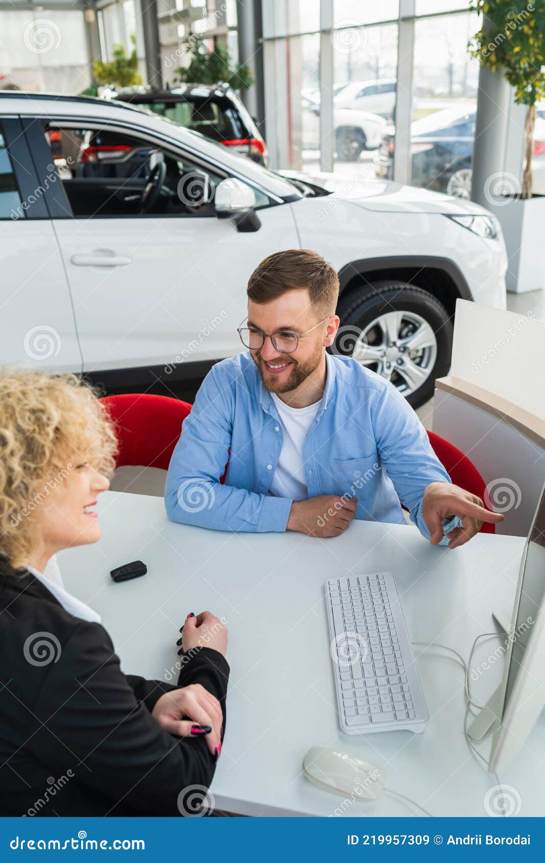 Car Dealership Manager with Client at Computer in Showroom. Stock Image ...