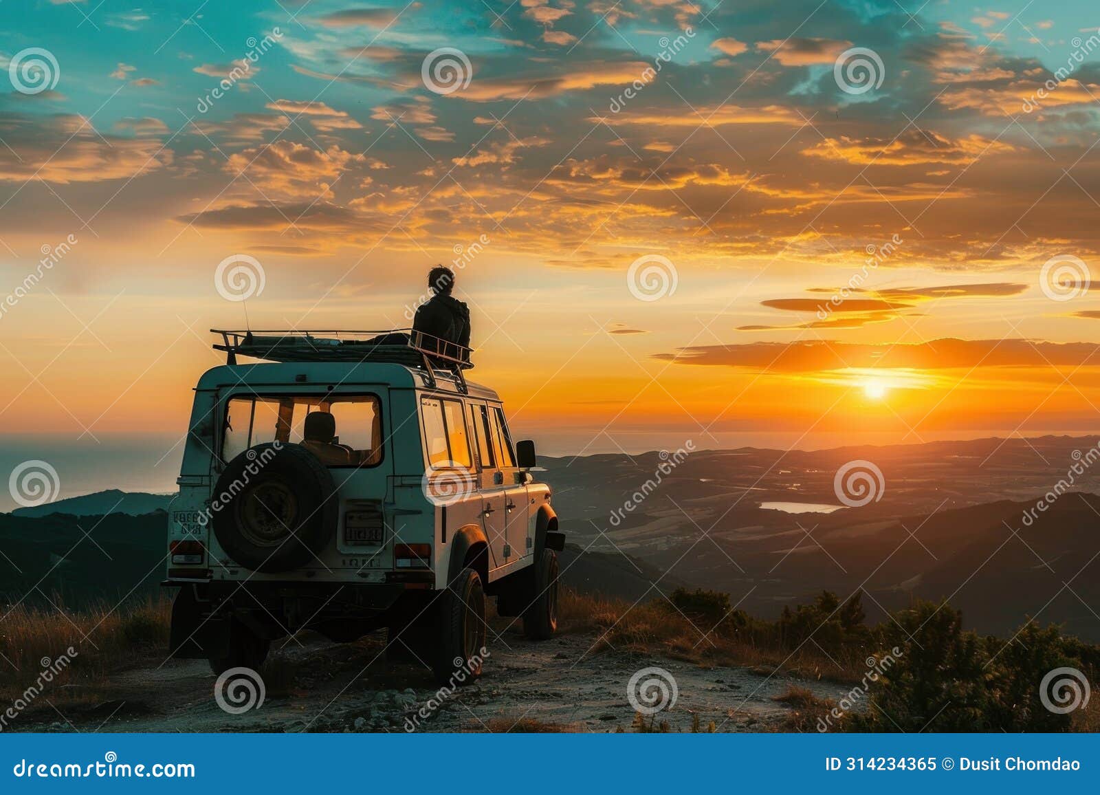 A Car is Driving Down a Road with a Beautiful Sunset in the Background ...