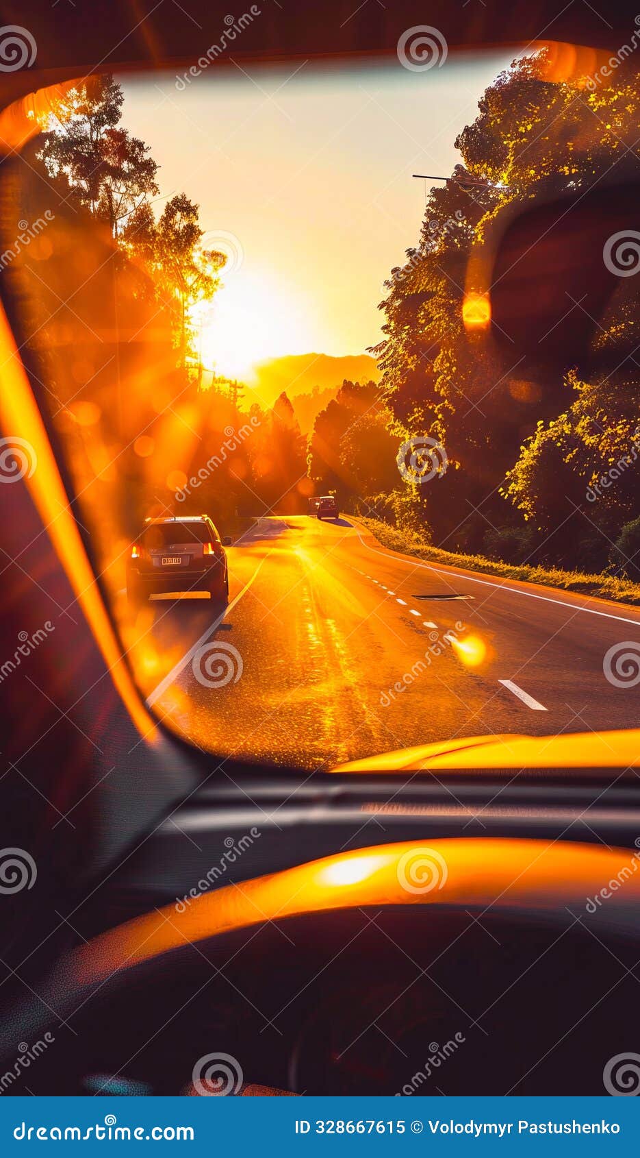 A Car Driving Down a Road at Sunset through a Rear View Mirror Stock ...