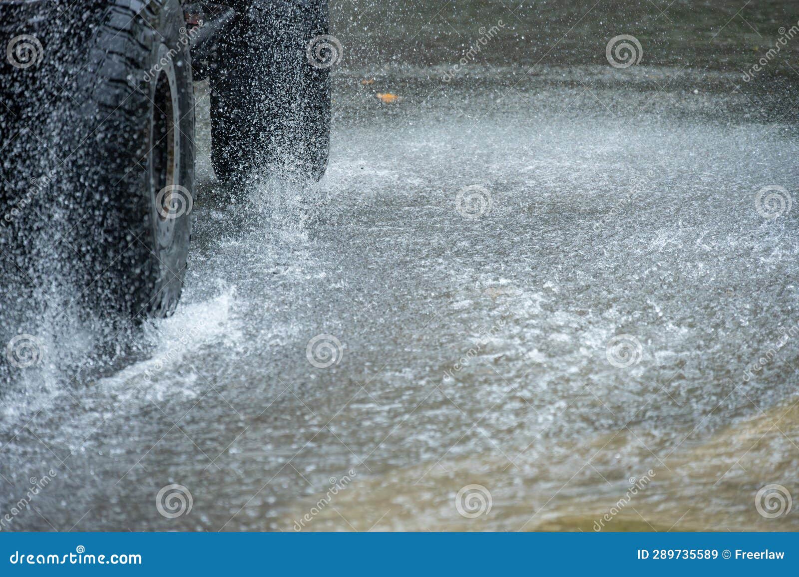 Car Driving through the Puddle and Splashing Water in a Raining Day ...
