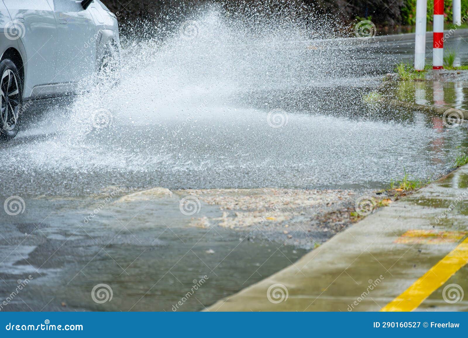Car Driving through the Puddle and Splashing Water in a Raining Day ...