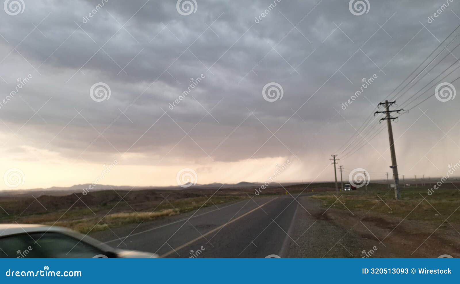 Car Driving on a Road with Clouds in the Sky Stock Image - Image of ...