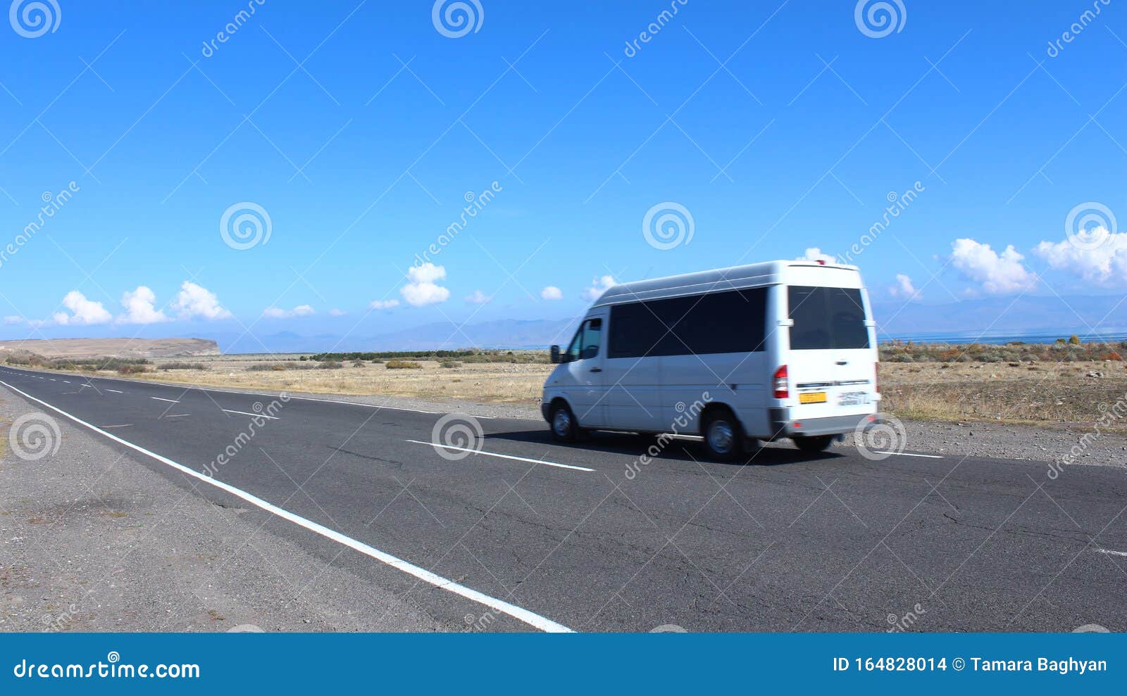 Car driving on the road stock photo. Image of clouds - 164828014