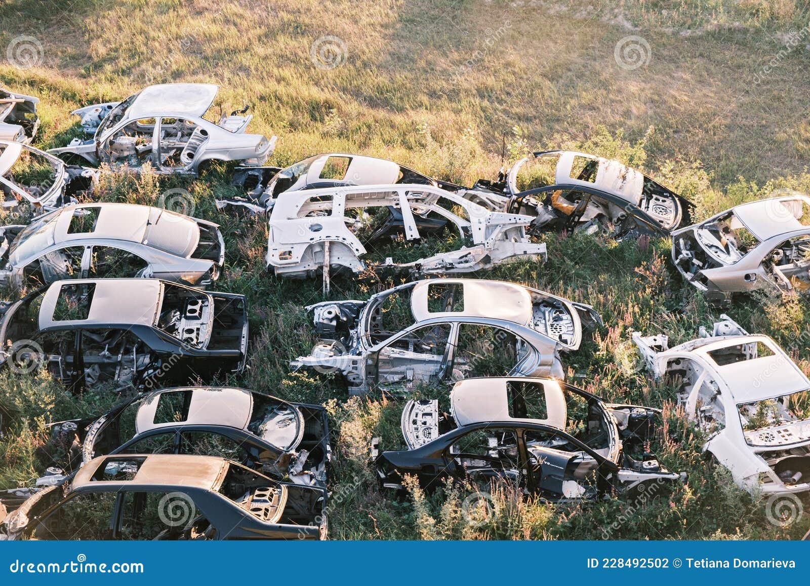 Car Dump. Broken Old Rusty Cars Lying on the Grass Stock Photo - Image ...