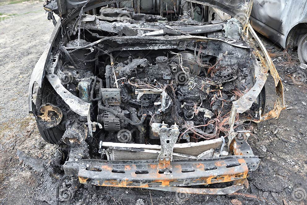 The Car after the Fire. Burnt Out Car with an Open Hood. Engine Burned ...