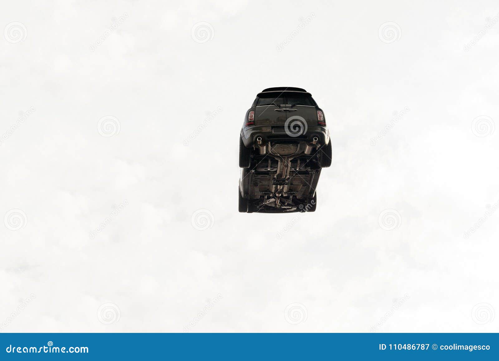 A Car Flying through the Air in the Pale Blue Sky with the Underside ...