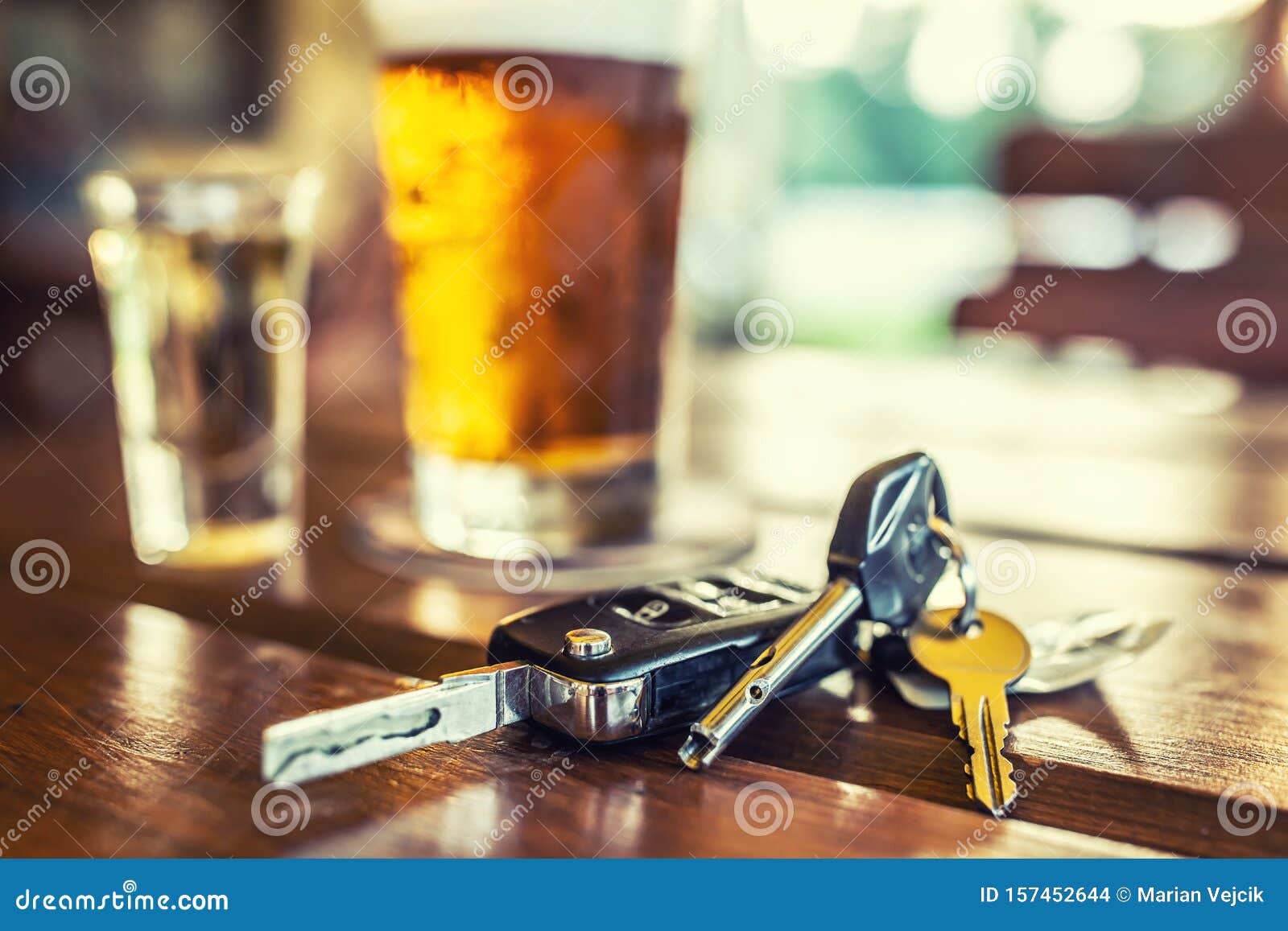Car Keys and Glass of Beer or Distillate Alcohol on Table in Pub or ...