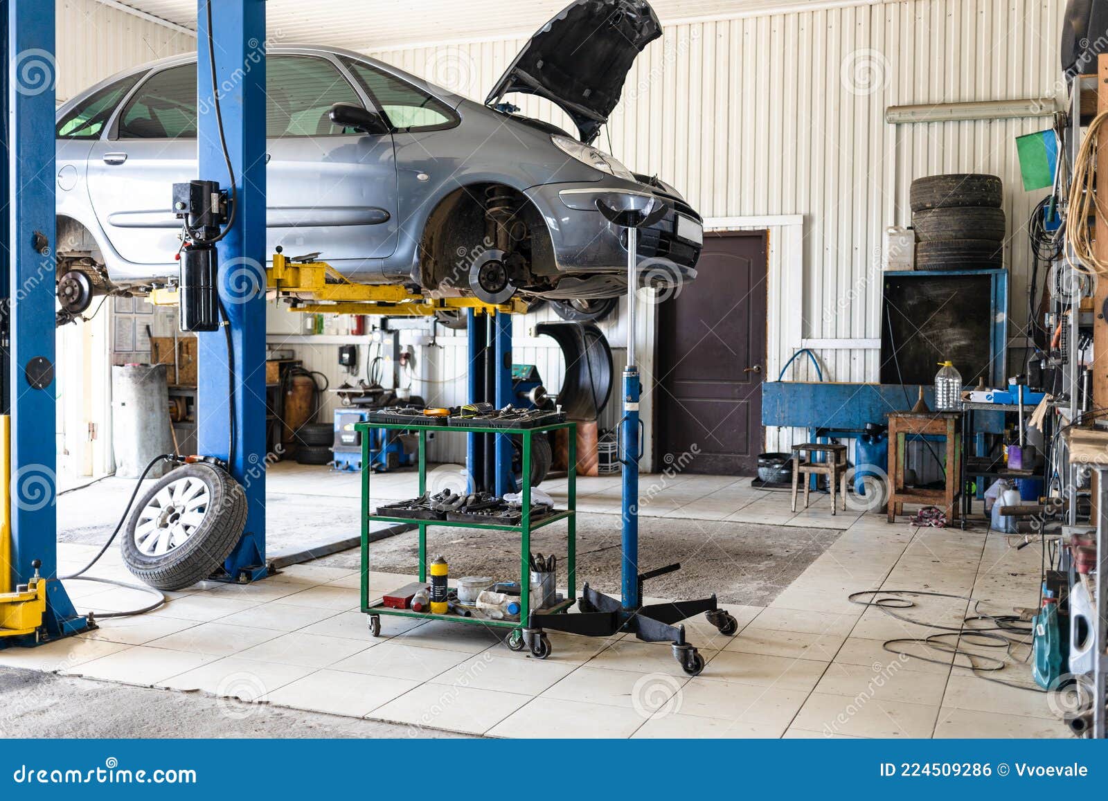Car is Lifted on Hydraulic Lift in Car Workshop Stock Photo - Image of ...