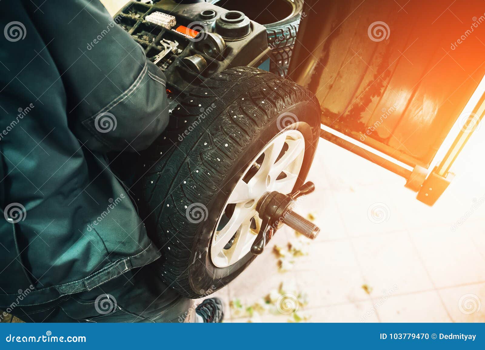 Car Mechanic Balancing Car Wheel on Computer Machine Balancer in Auto ...
