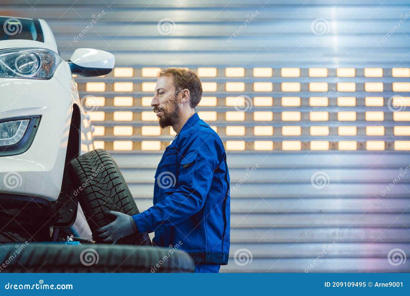 Car Mechanic Changing Tire in His Workshop Stock Image - Image of bluey ...
